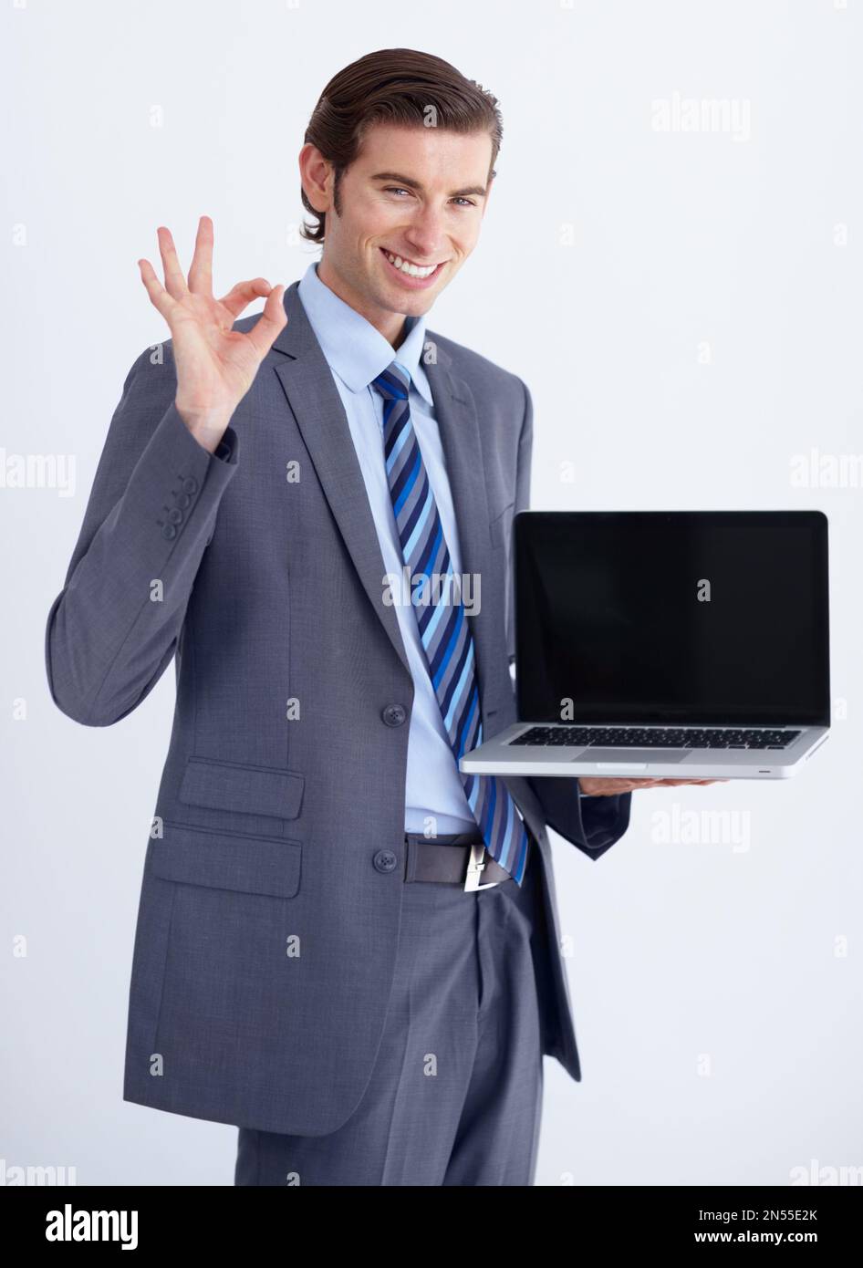 Take my word for it. A young businessman endorsing a laptop with an a ...