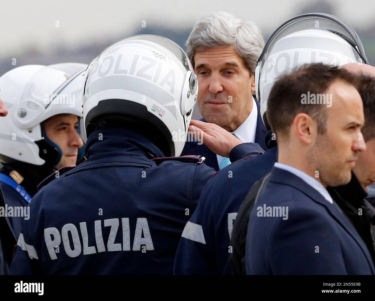 U.S. Secretary of State John Kerry is greeted by a Police officer as he ...