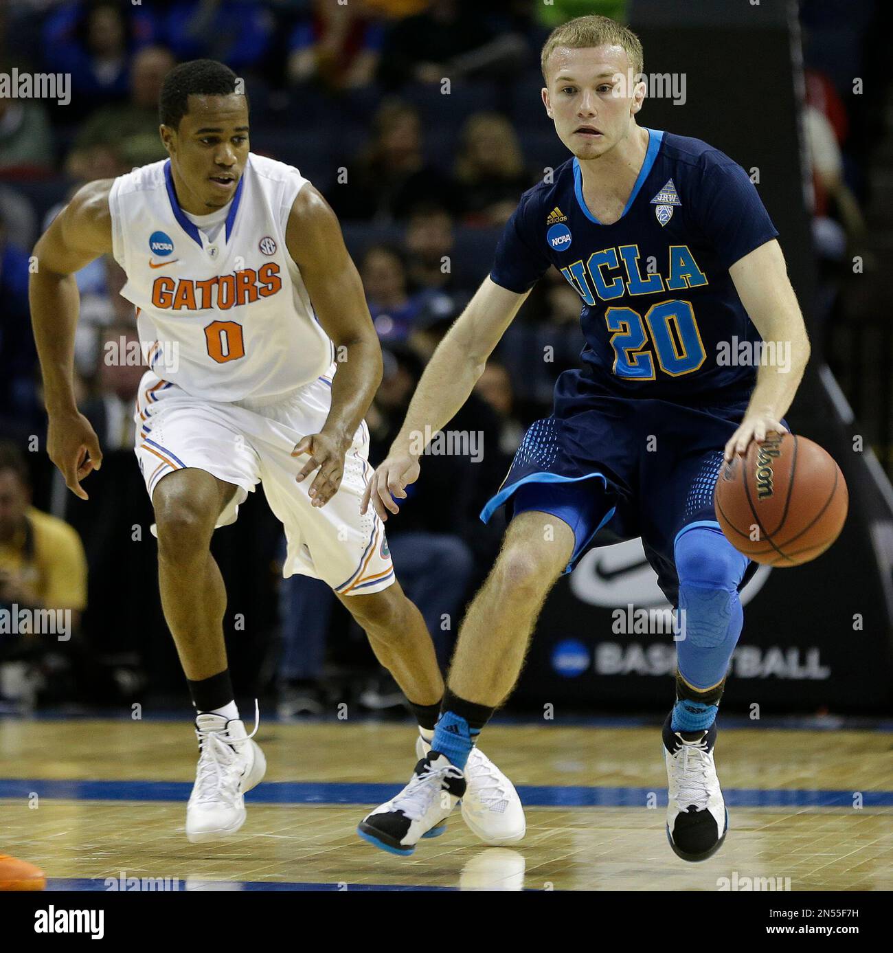 UCLA guard Bryce Alford (20) moves the ball against Florida's Kasey ...