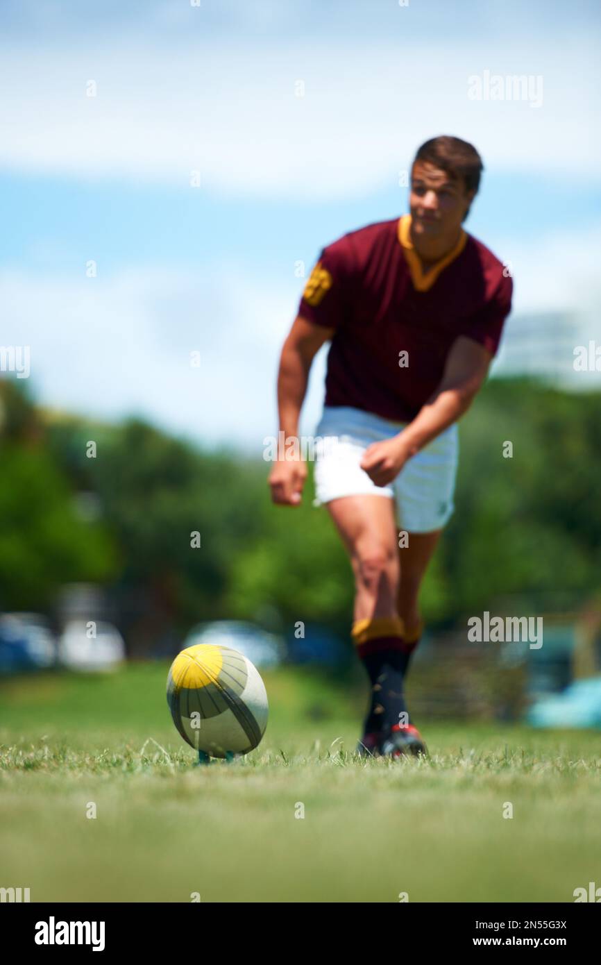 A big moment. Full length shot of a young rugby player kicking for ...