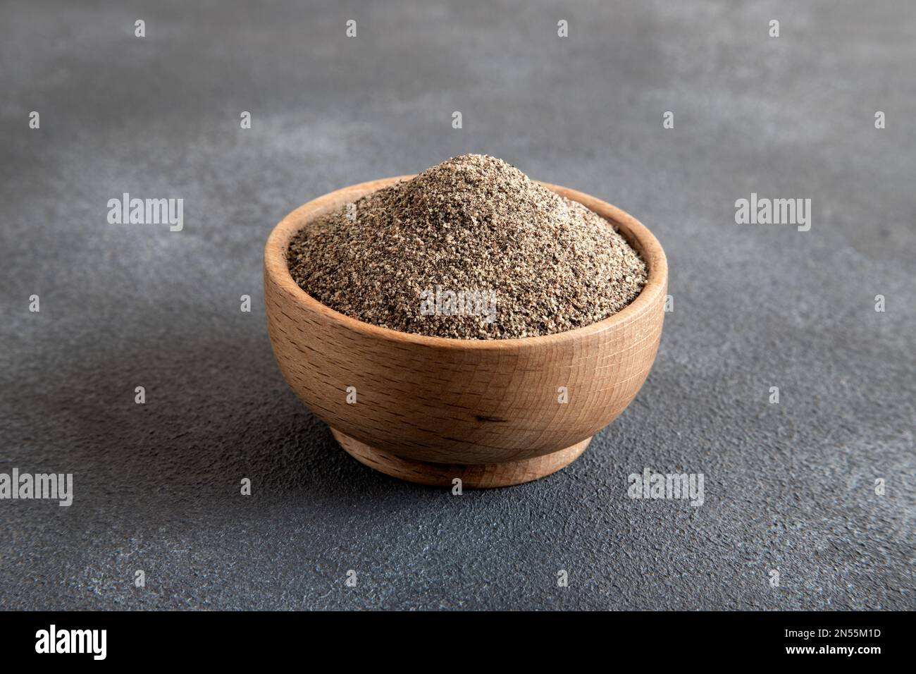Powder black pepper on black background, top view Stock Photo - Alamy