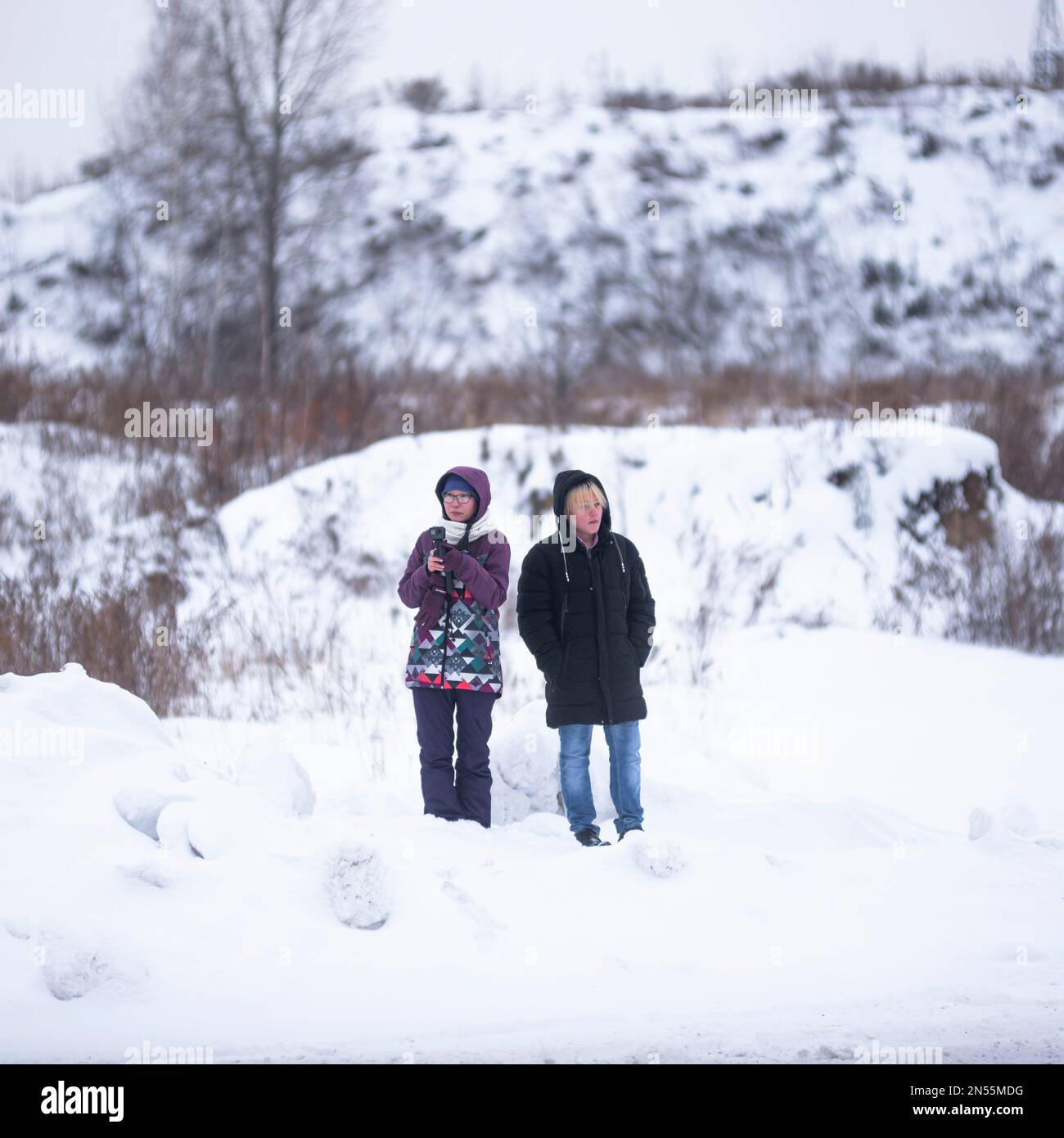 A fashionable young man with white colored hair without a hat in winter ...