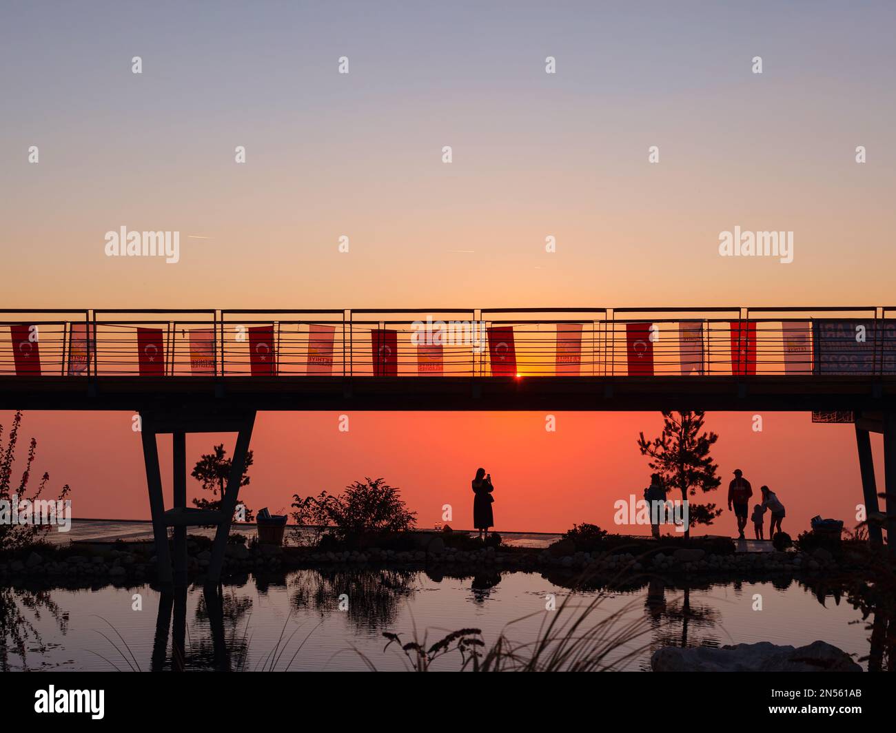 silhouette of park and people on observation deck against sunset sky ...
