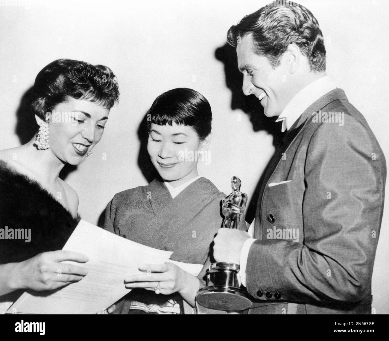 Hugh O'Brien holds the Oscar won by Miyoshi Umeki, the first Japanese ...
