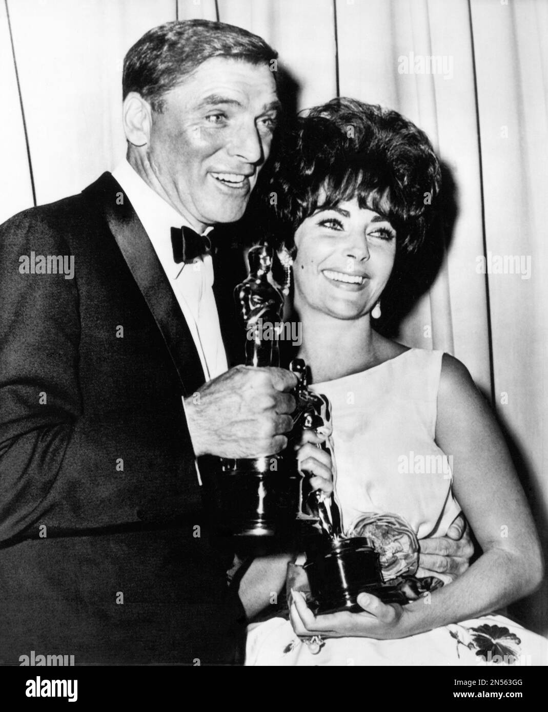 Burt Lancaster and Elizabeth Taylor hold the Oscars they won for best ...