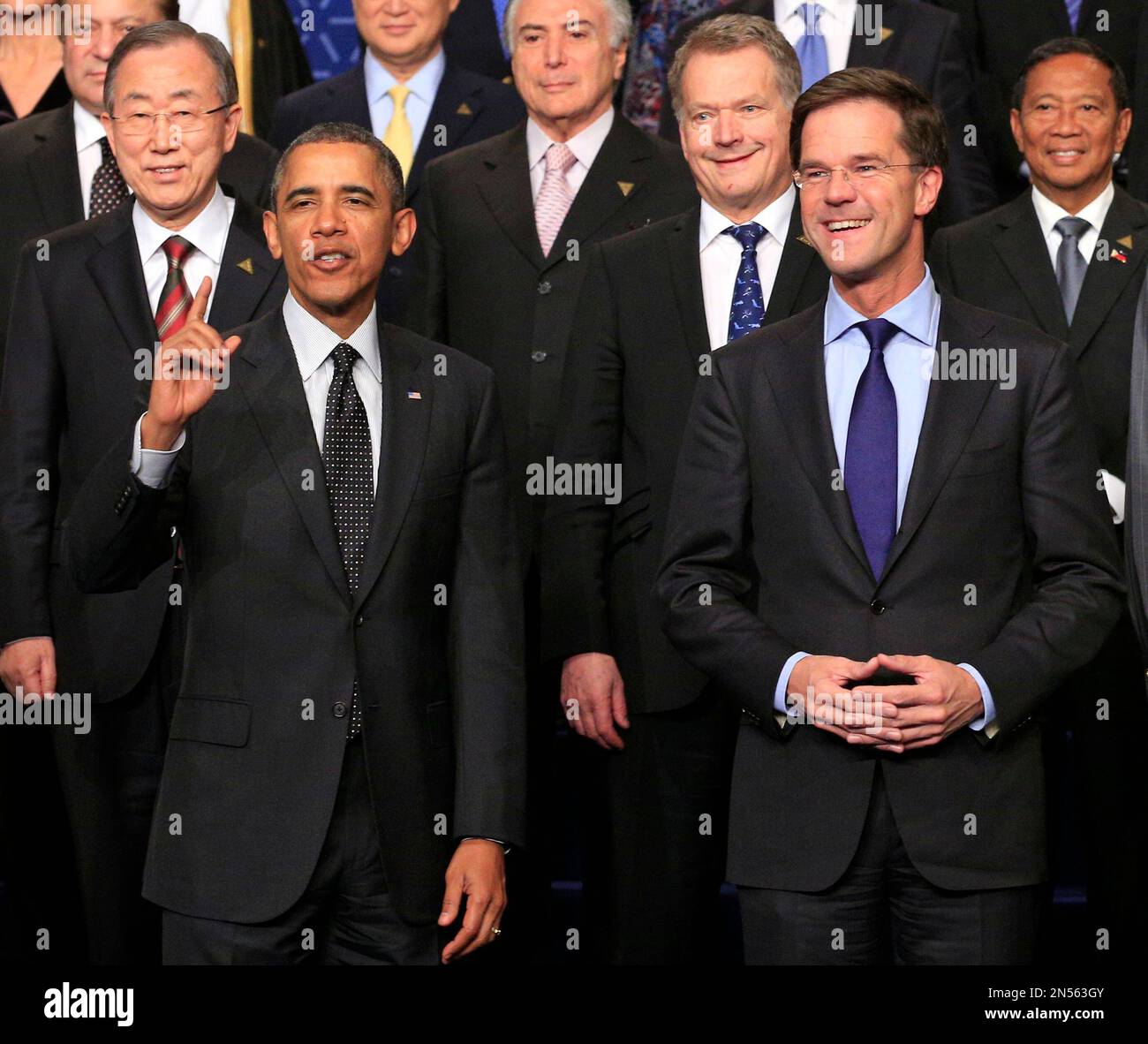 U.S. President Barack Obama, left, points his finger as he poses for a ...