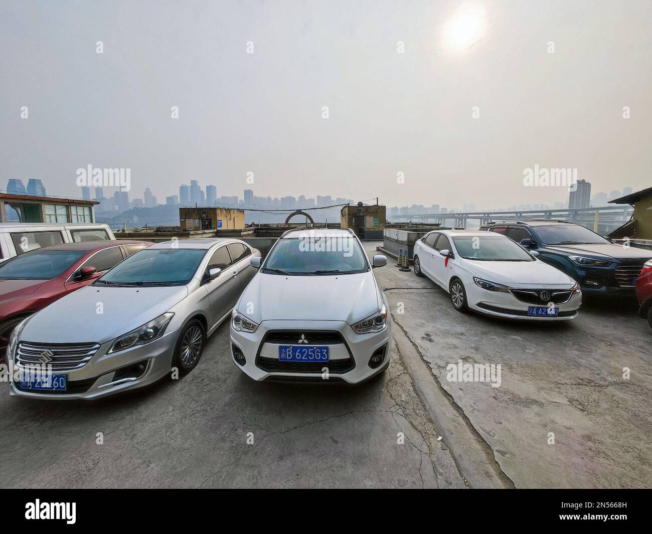 Aerial photo shows a parking lot built on the roof of a residential ...