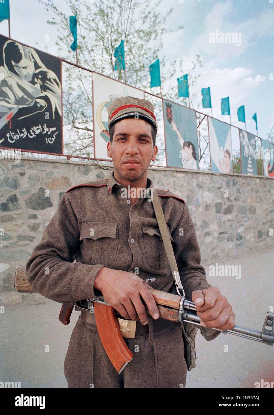 A Afghan soldier with a Soviet-supplied Kalashnikov rifle stands in ...
