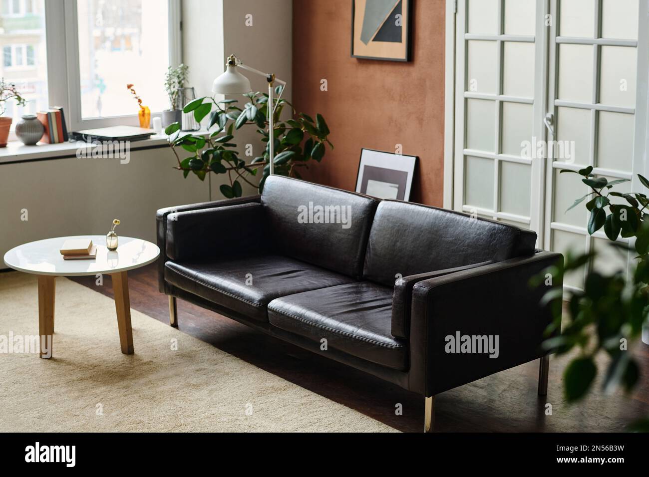 Horizontal image of light modern living room with leather sofa in the ...