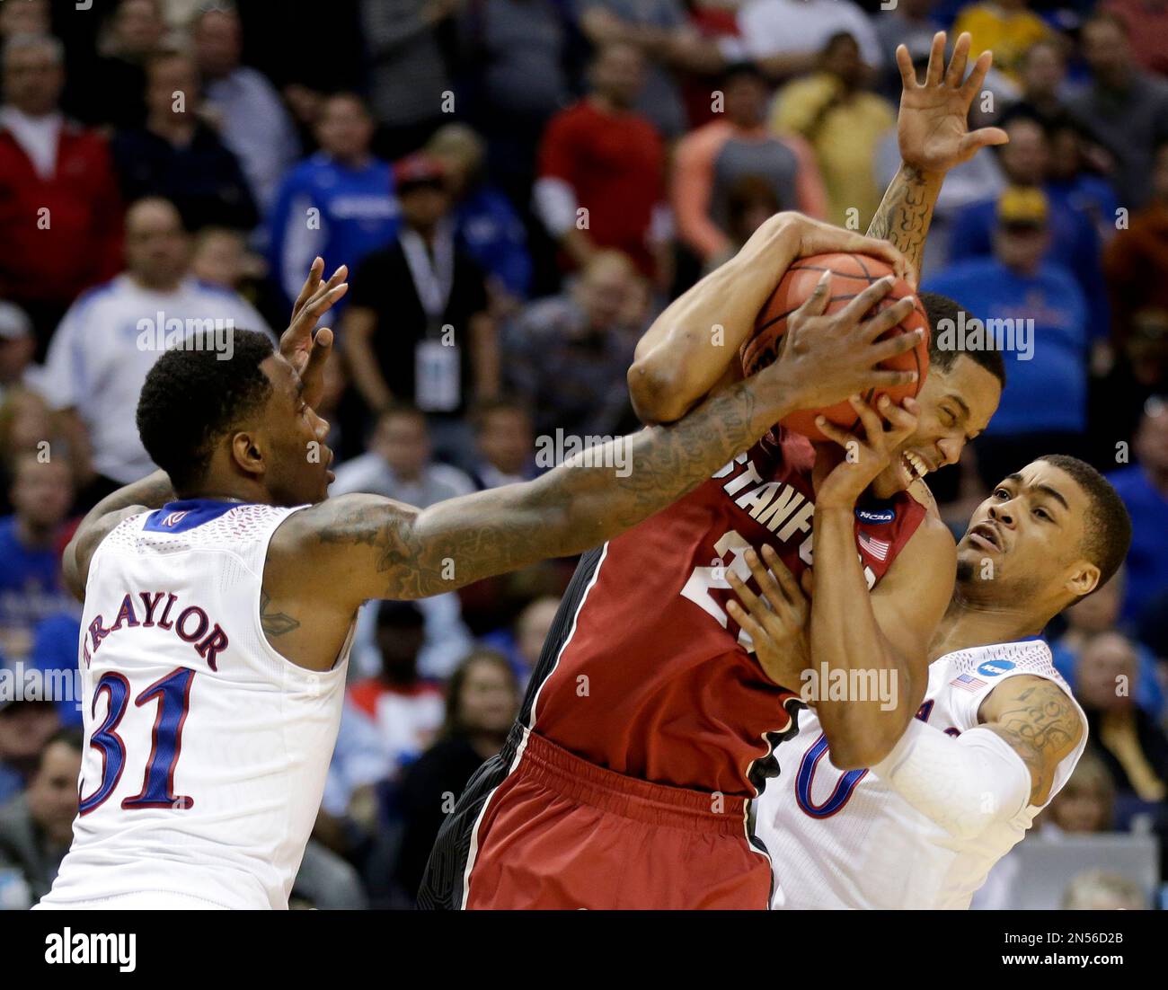 Kansas's Jamari Traylor (31) and Frank Mason (0) try to steal the ball ...