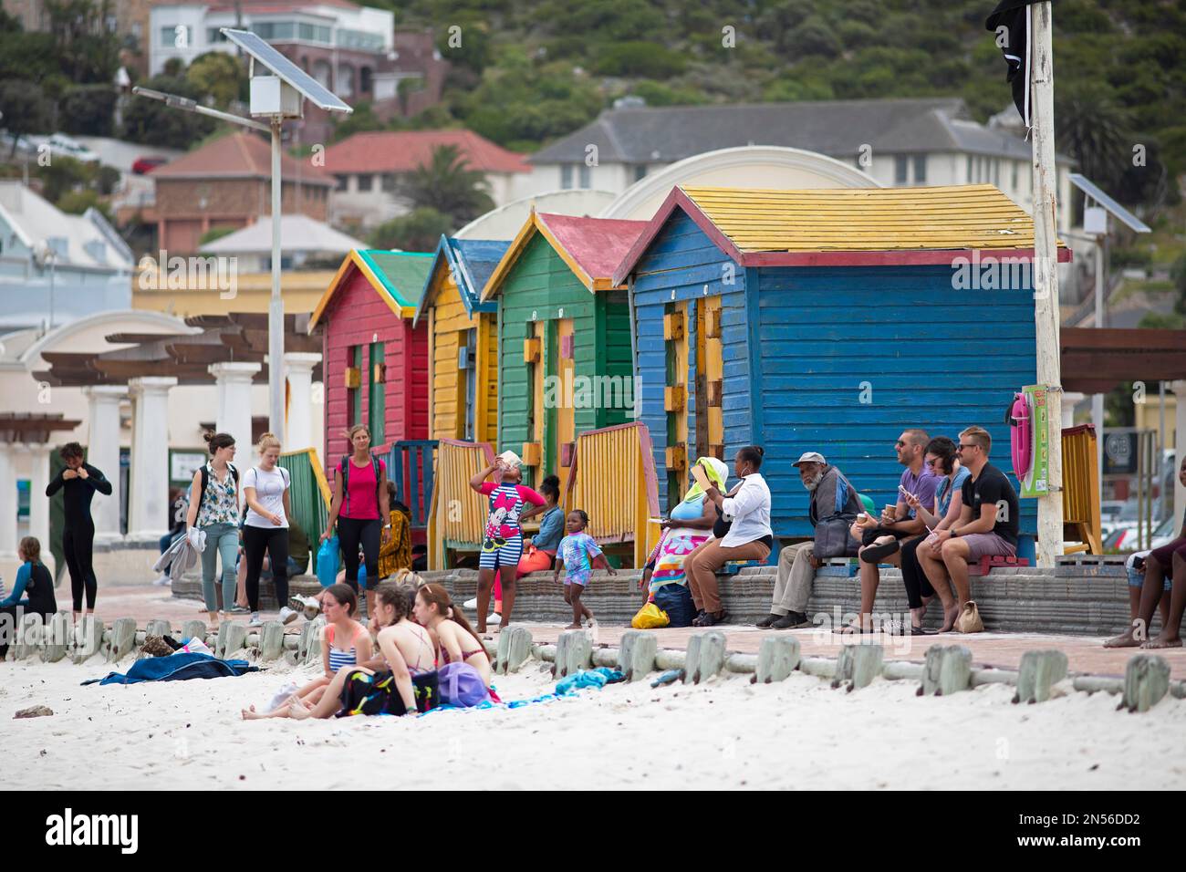 Holidaymakers in front of colourful beach huts, Muizenberg, Western ...