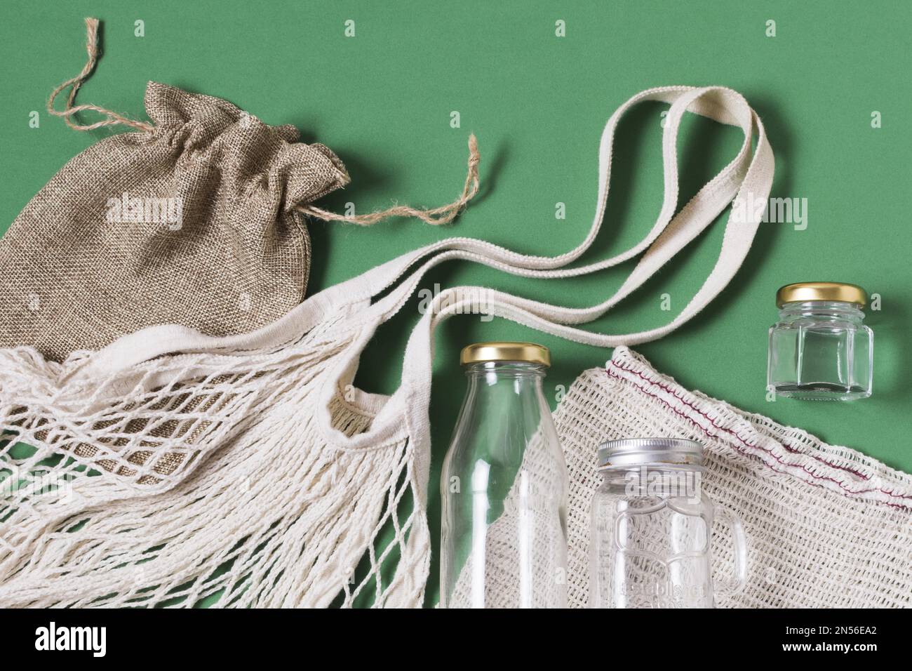 top view different zero waste products green background. Resolution and ...