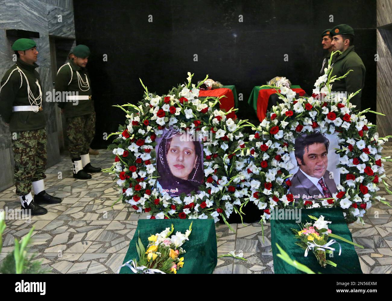 Afghan guards of honor stand next to the coffins of Agence France-Press ...