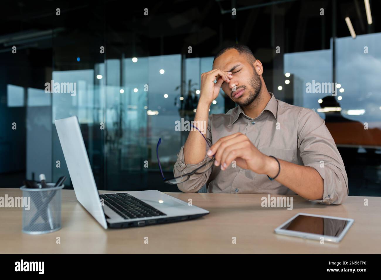 Tired and upset businessman inside office at work sitting at workplace ...