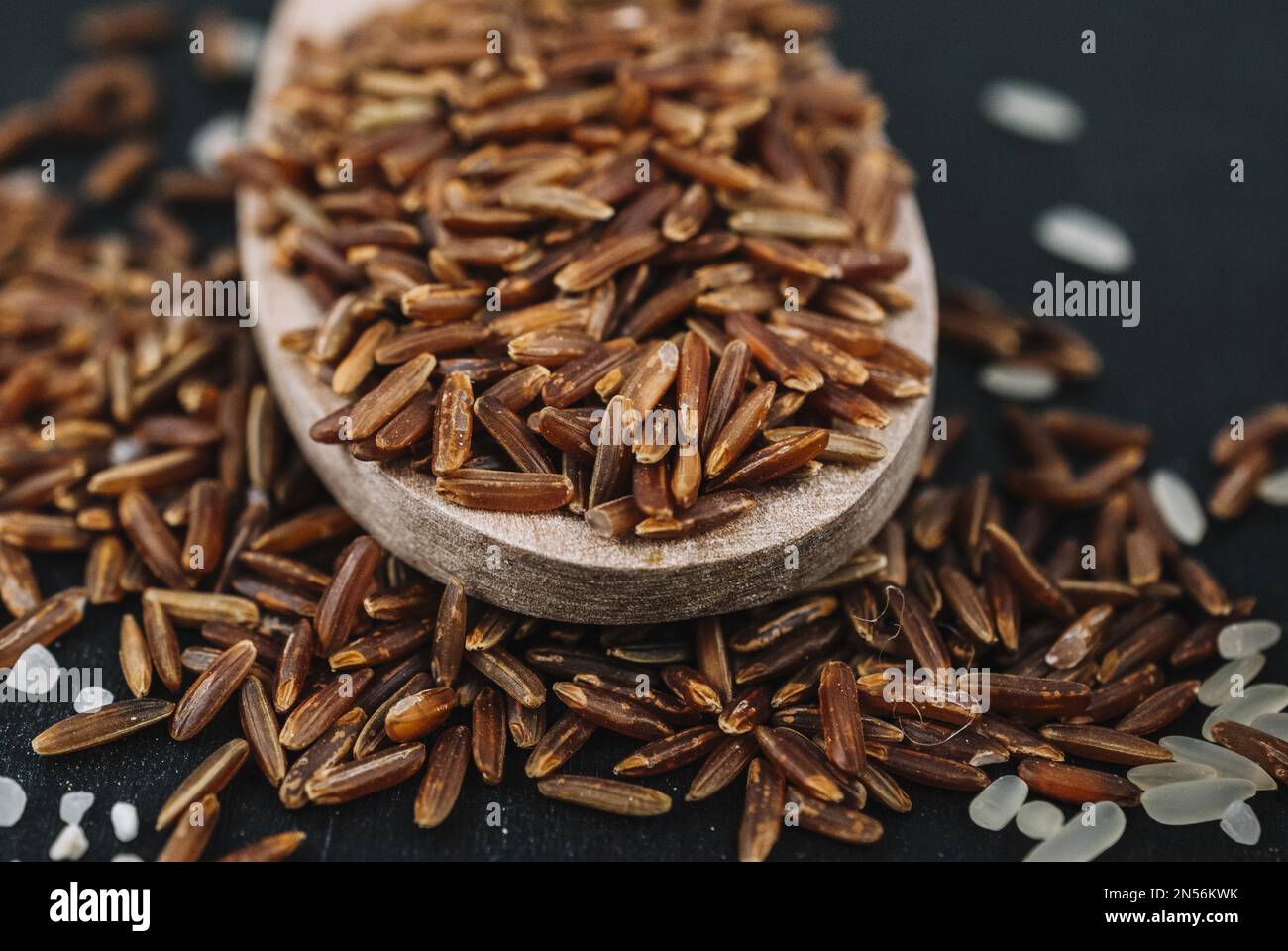 spoon with brown rice spilled grains. Resolution and high quality ...