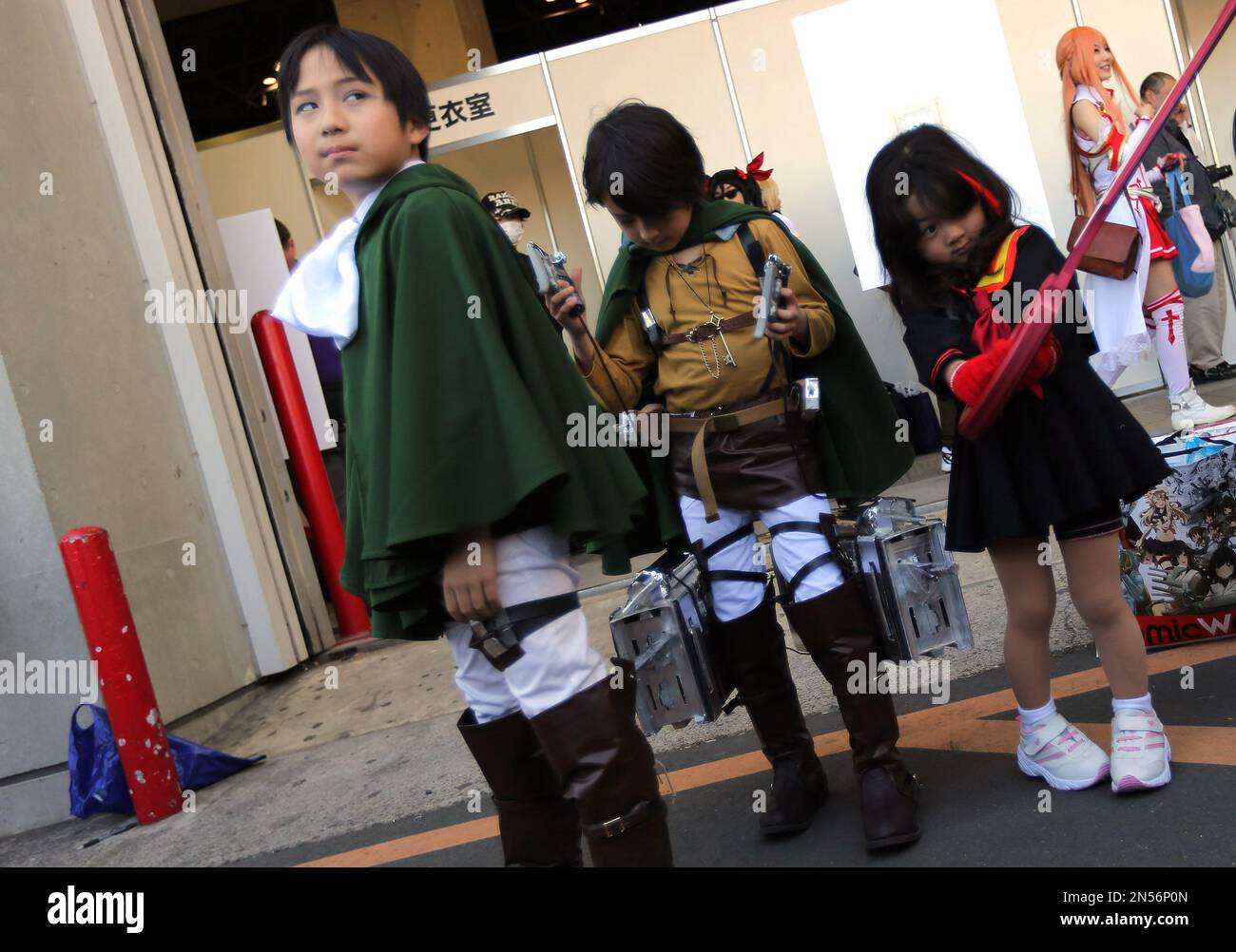 Young costume players or cosplayers pose for anime fans during ...