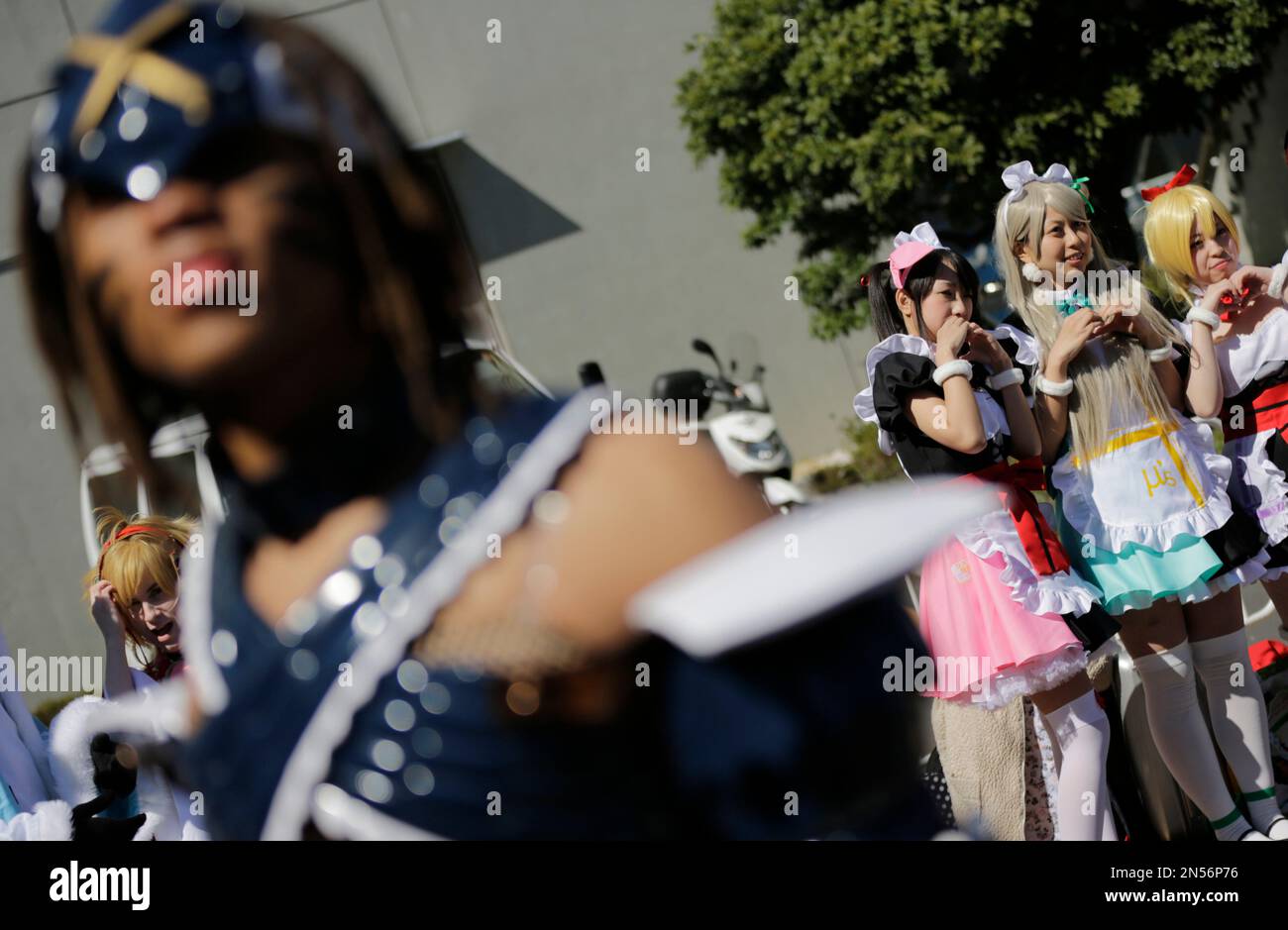 Costume players, or cosplayers, pose for anime fans during AnimeJapan ...