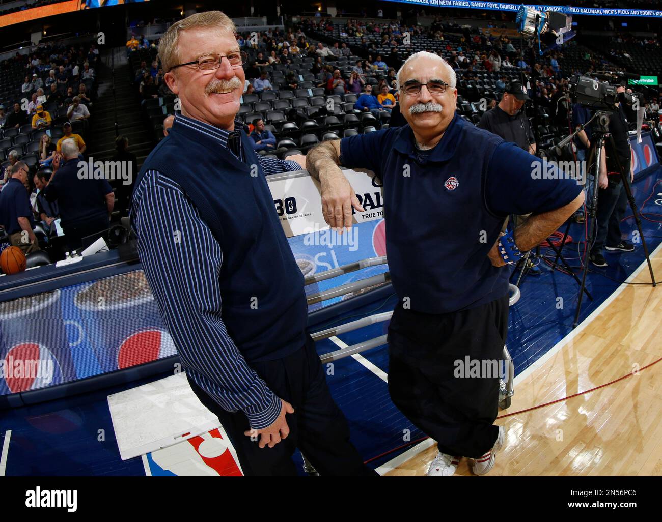 Denver Nuggets head trainer Jim Gillen, left, jokes with Detroit ...