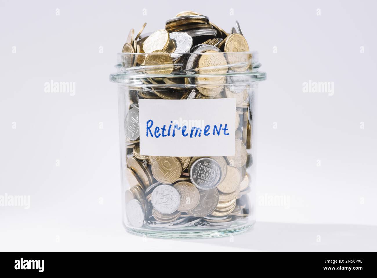 retirement glass container full coins white backdrop . Resolution and ...