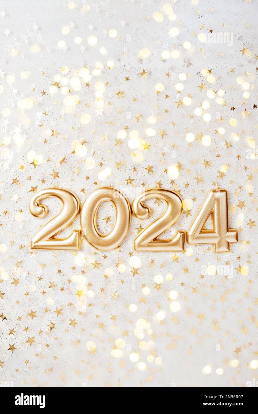 Holiday background Happy New Year 2024. Numbers of year 2024 made by gold candles on bokeh ...