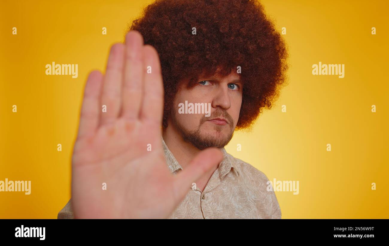 No stop. Serious man say No, hold palm folded crossed hands in stop ...