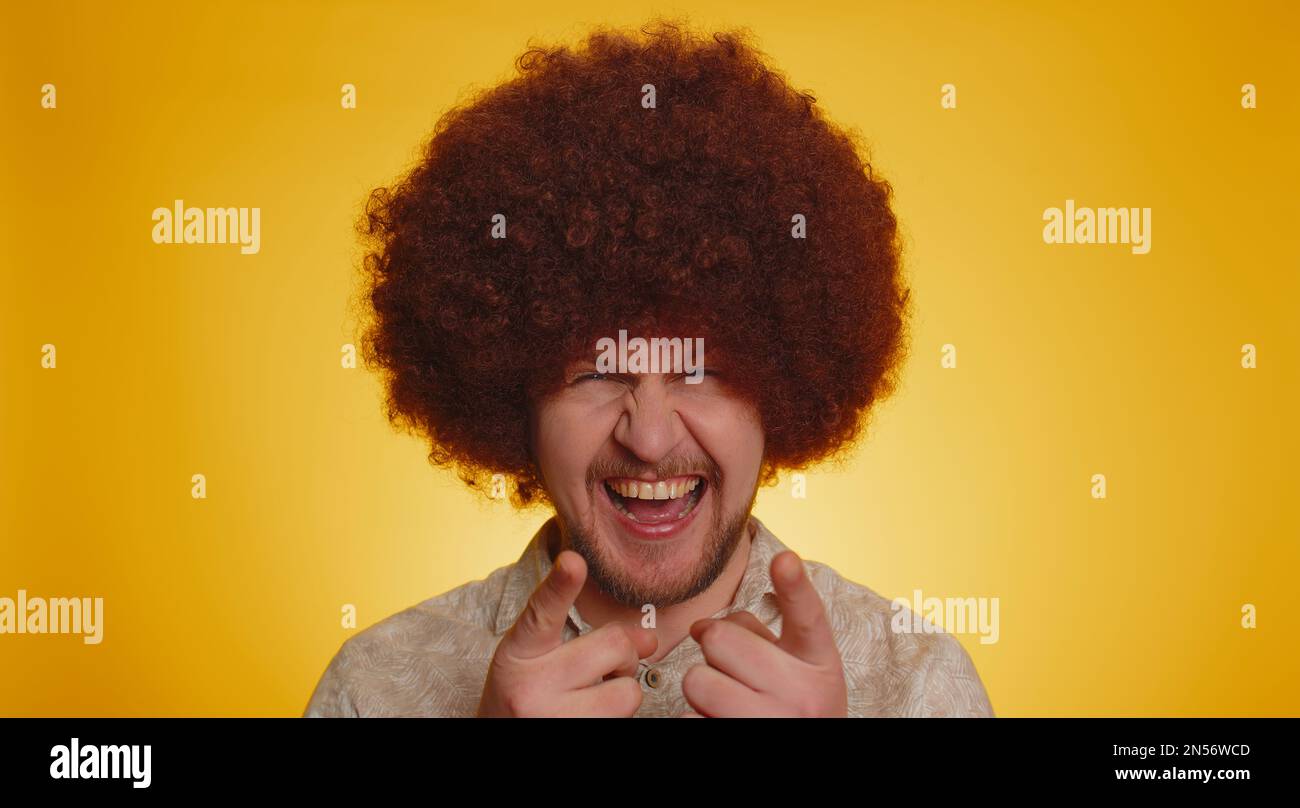 Joyful man with lush Afro hairstyle coiffure laughing out loud after ...