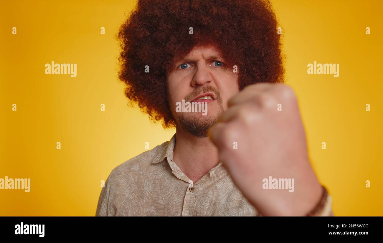 Quarrel. Displeased man with lush Afro hairstyle gesturing hands with ...