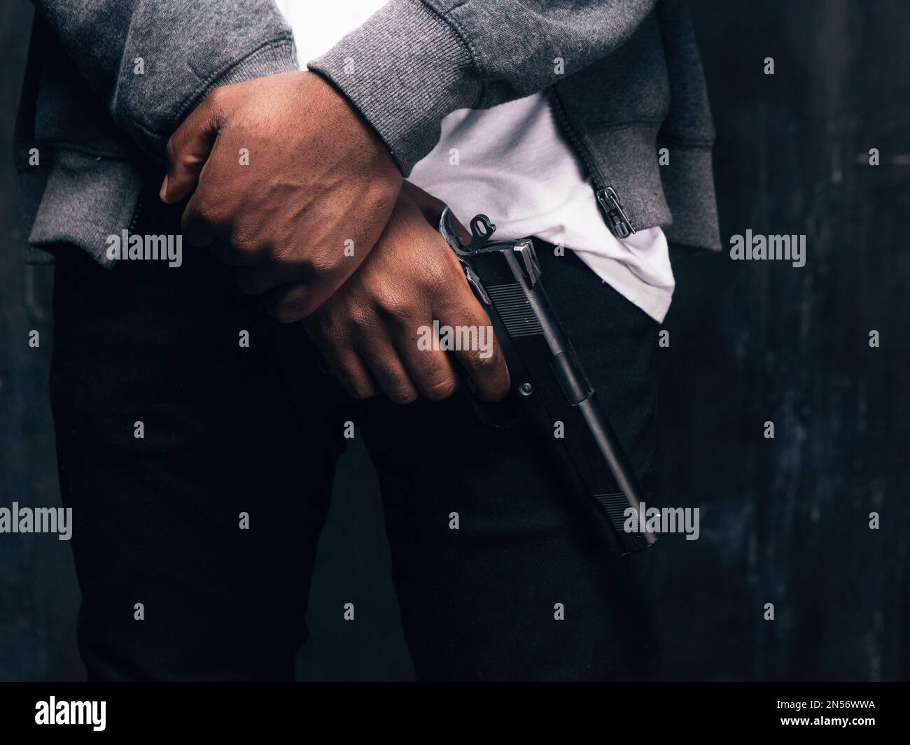 Unrecognizable armed black gangster Stock Photo - Alamy