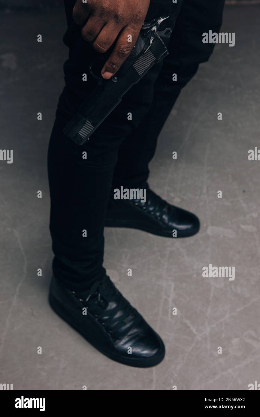 Unrecognizable armed black criminal man hi-res stock photography and ...