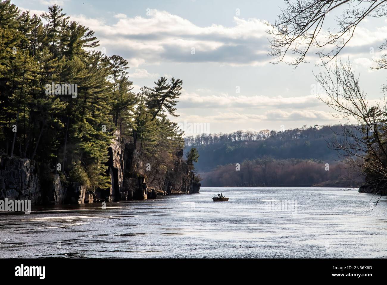 Fishing on the St. Croix River in Interstate State Park with the river bluffs alongside of them ...