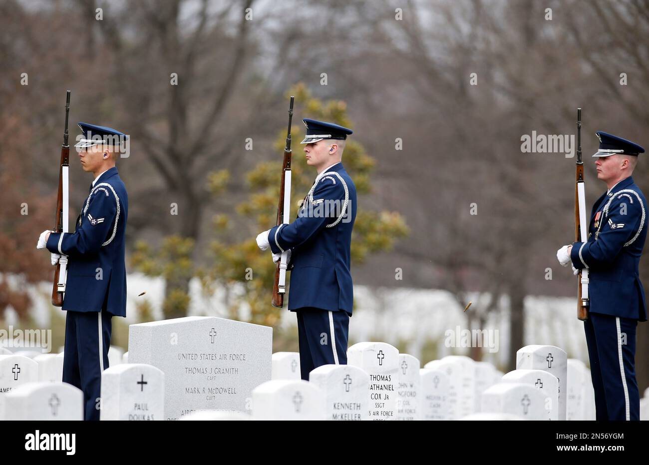 A U.S. Air Force firing party ejects spent casings after firing one of ...