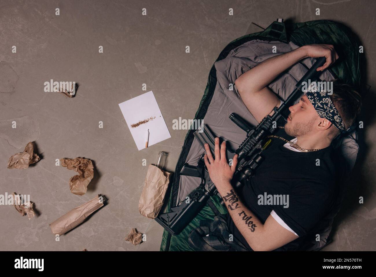 Soldier is sleeping with a rifle. Bad habits Stock Photo - Alamy