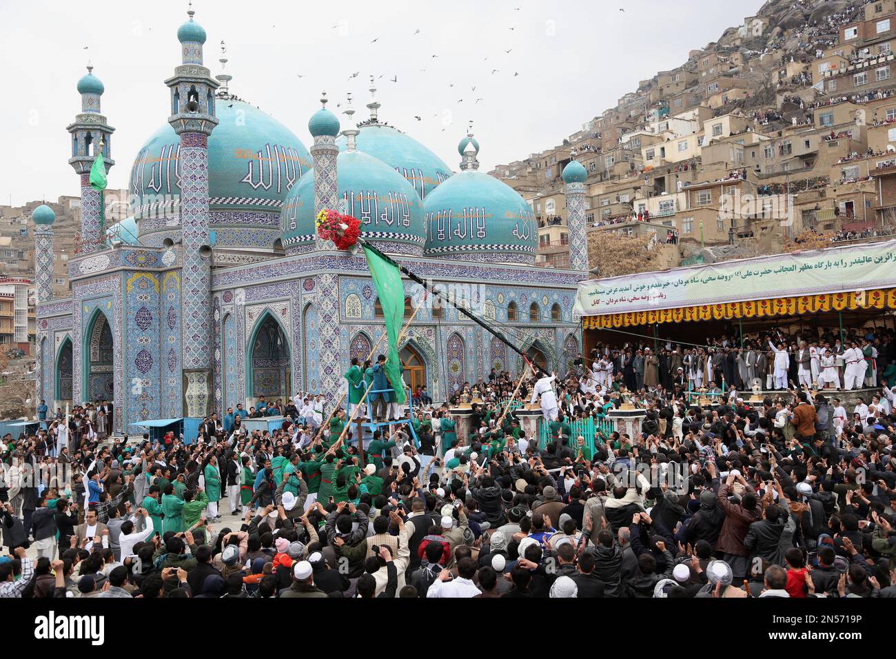 Afghan men hoist the holy mace during celebrations of Nowruz, the ...