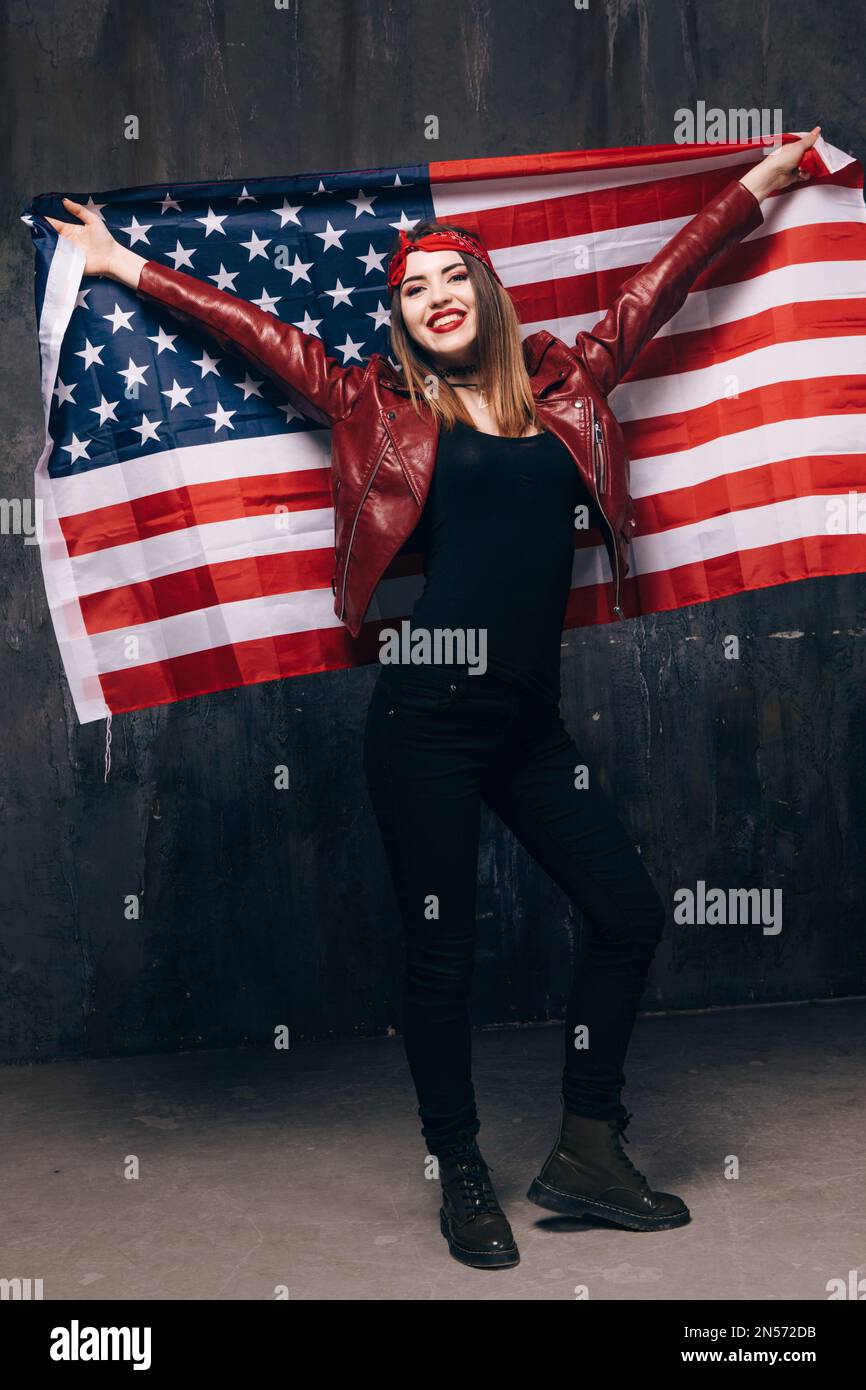 Happy smiling girl with USA flag behind the back Stock Photo - Alamy