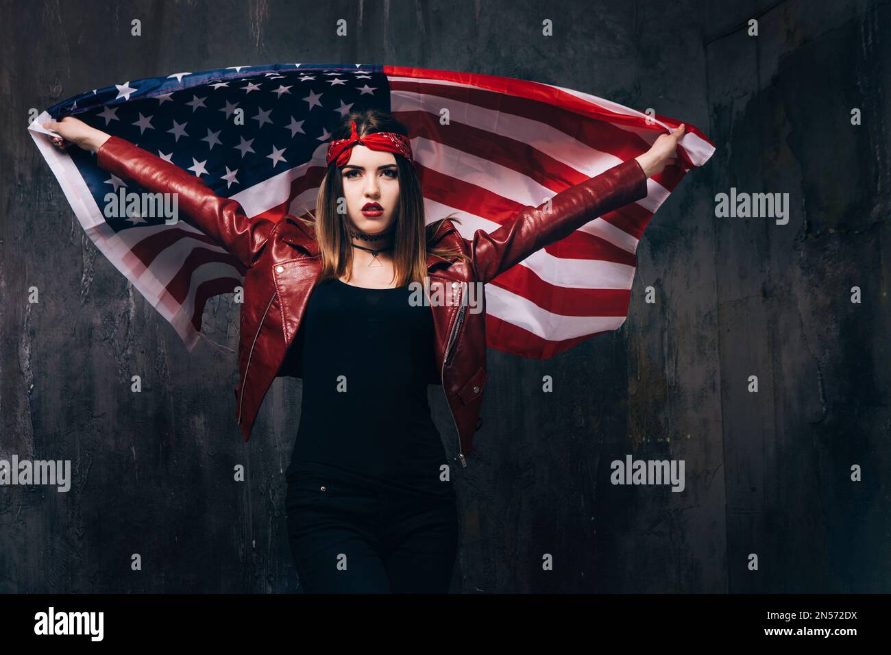 Girl with flying american flag behind the back Stock Photo - Alamy