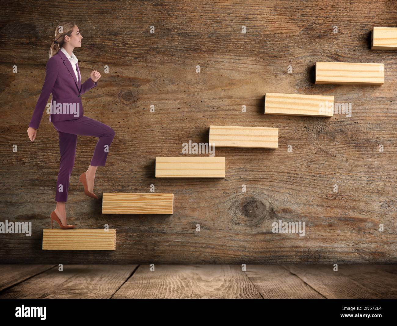 Businesswoman walking up stairs against wooden background. Career ...