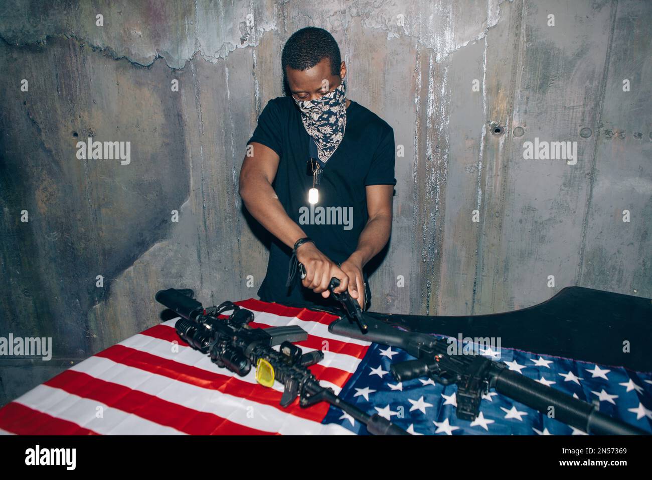 Black gun dealer checks a weapon Stock Photo - Alamy