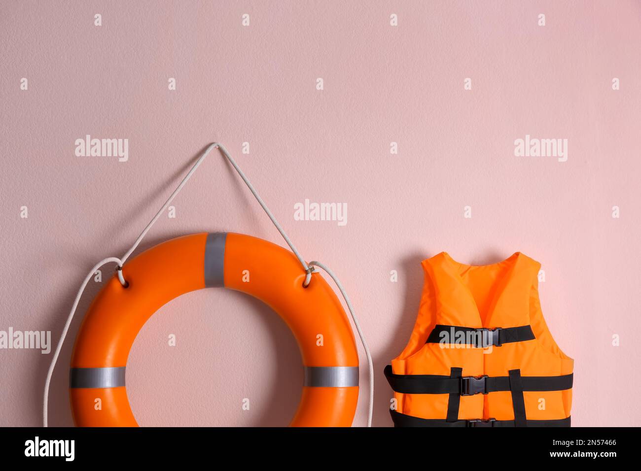 Orange life jacket and lifebuoy on pink background. Rescue equipment Stock Photo - Alamy