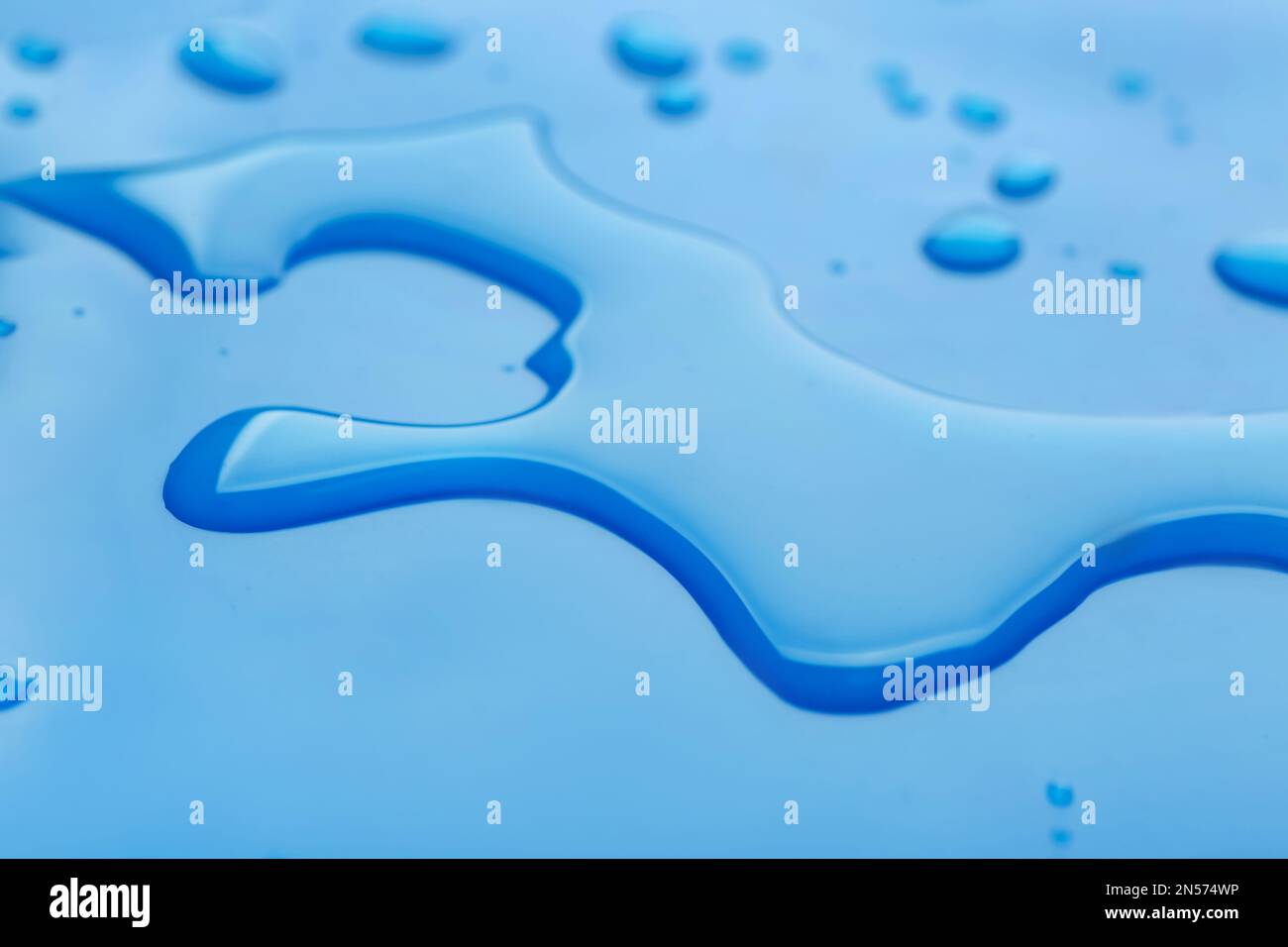 Drops of spilled water on blue background, closeup Stock Photo - Alamy