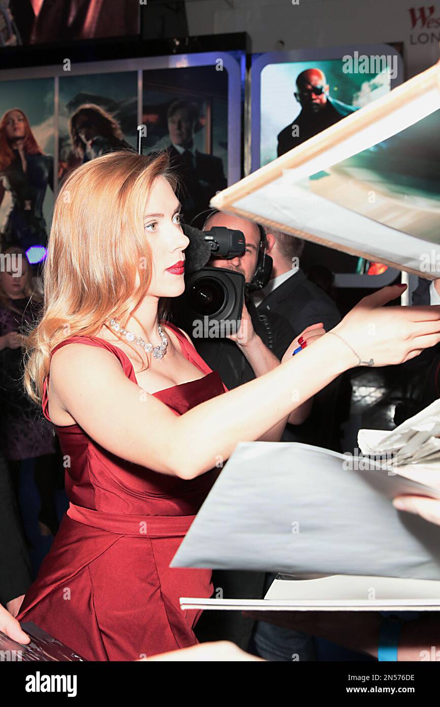 Actress Scarlett Johansson signs autographs for fans as she arrives at ...