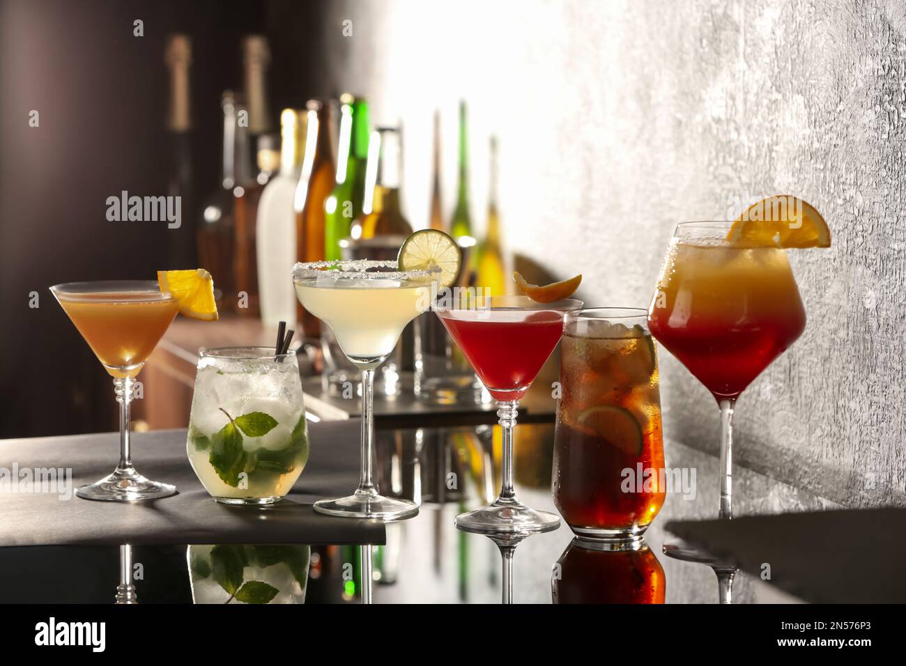 Different delicious cocktails on black table in bar Stock Photo - Alamy