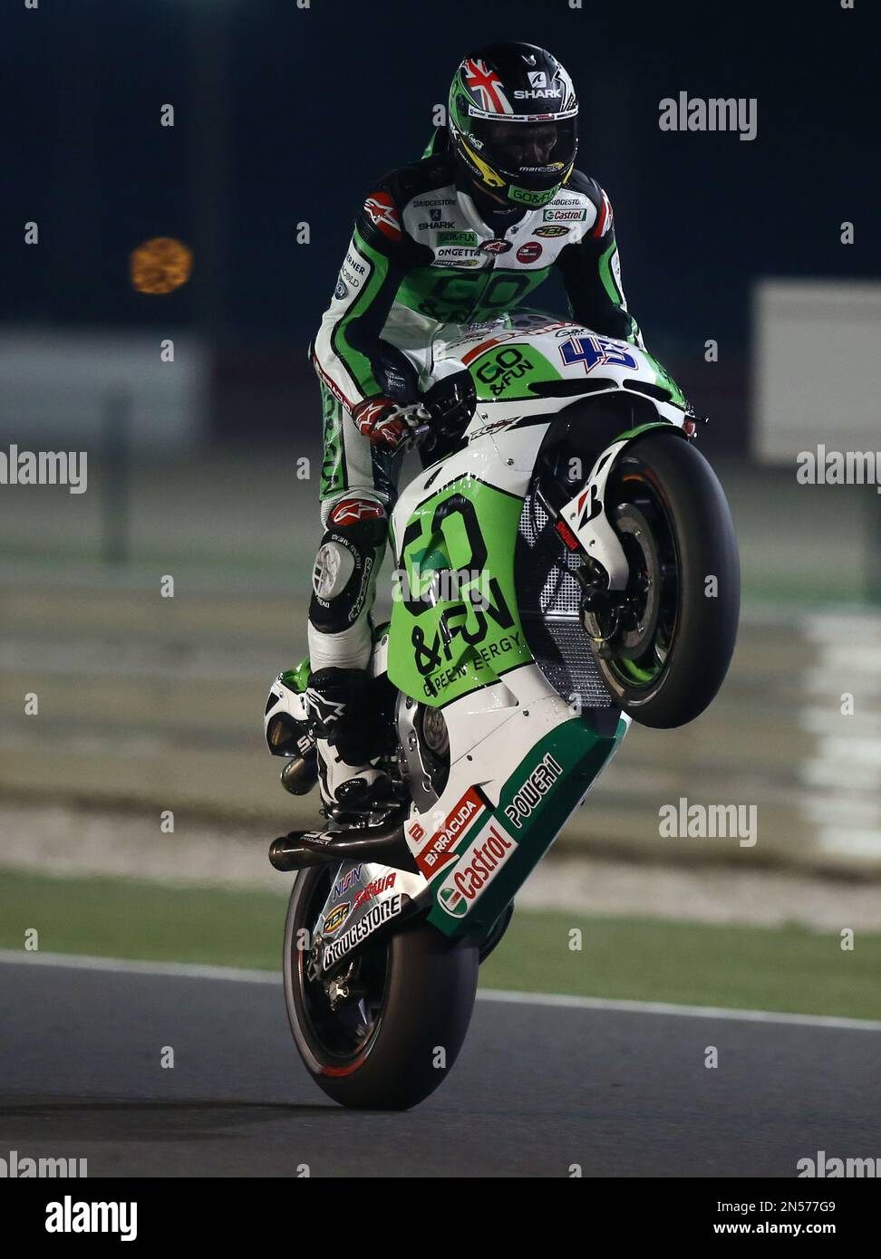 GO&FUN Honda MotoGP rider Scott Redding of Great Britain does a wheelie ...