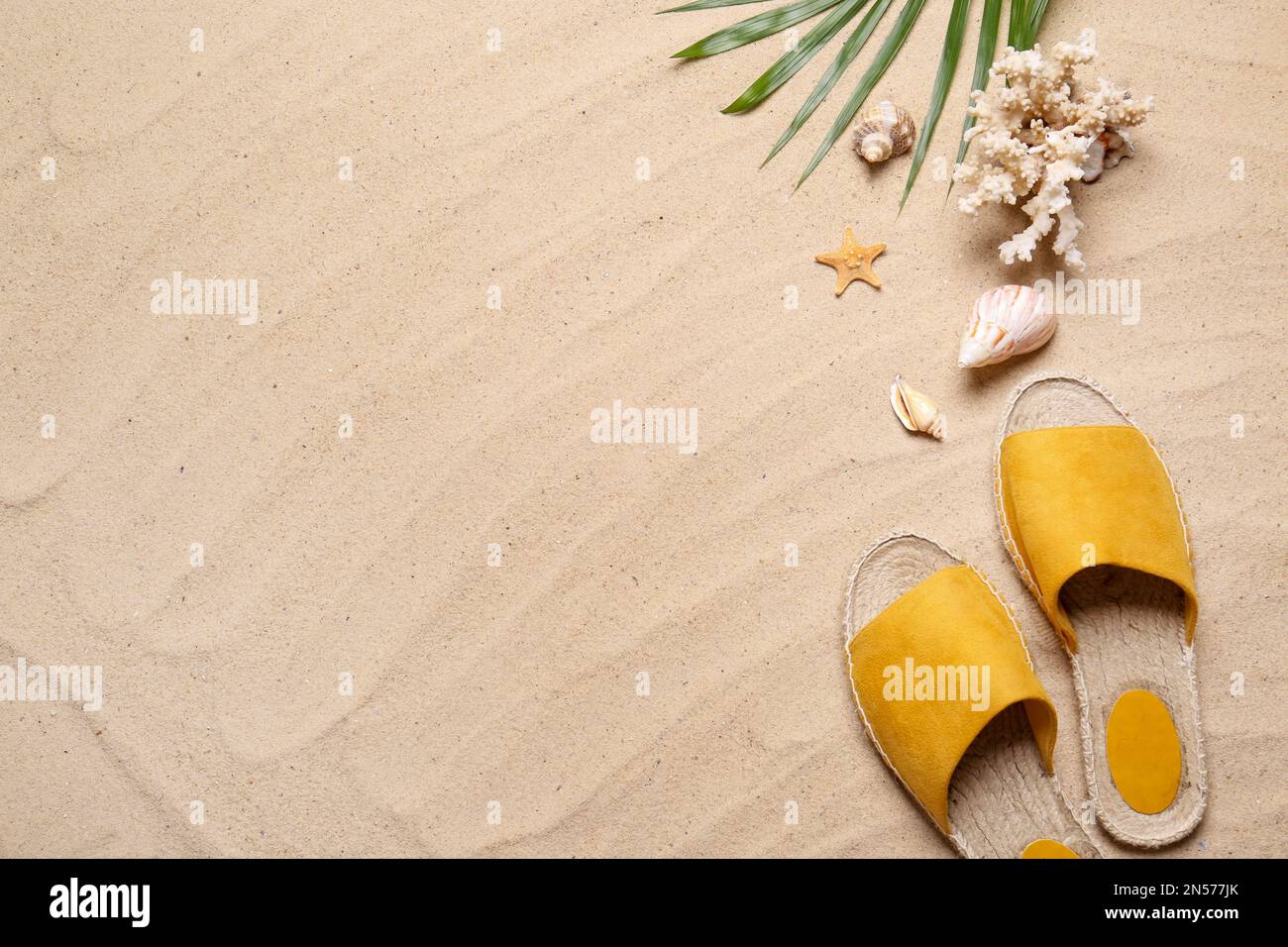 Flat lay composition with beach items on sand, space for text. Summer ...