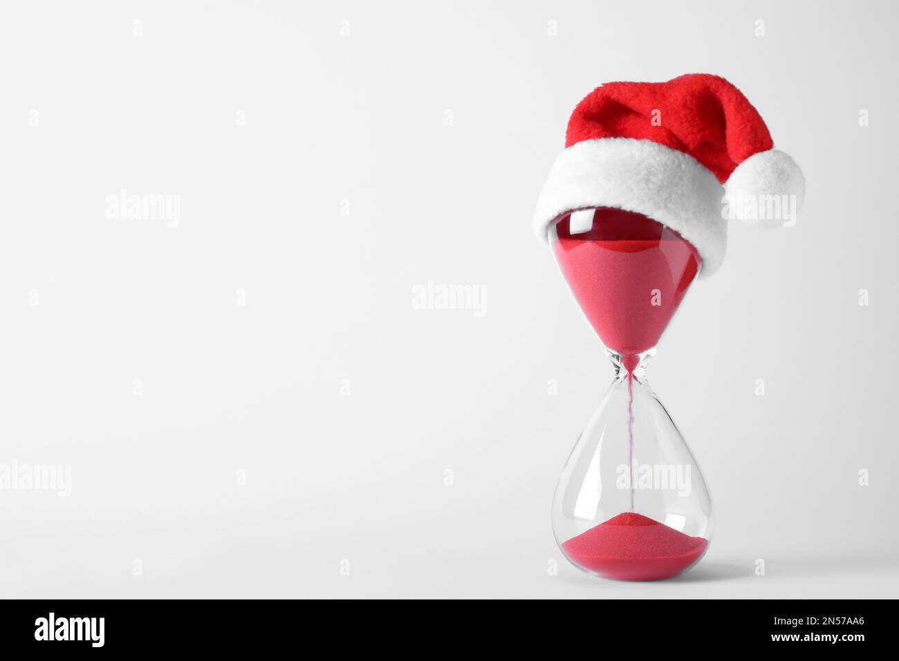 Hourglass with Santa hat isolated on white. Christmas countdown Stock ...