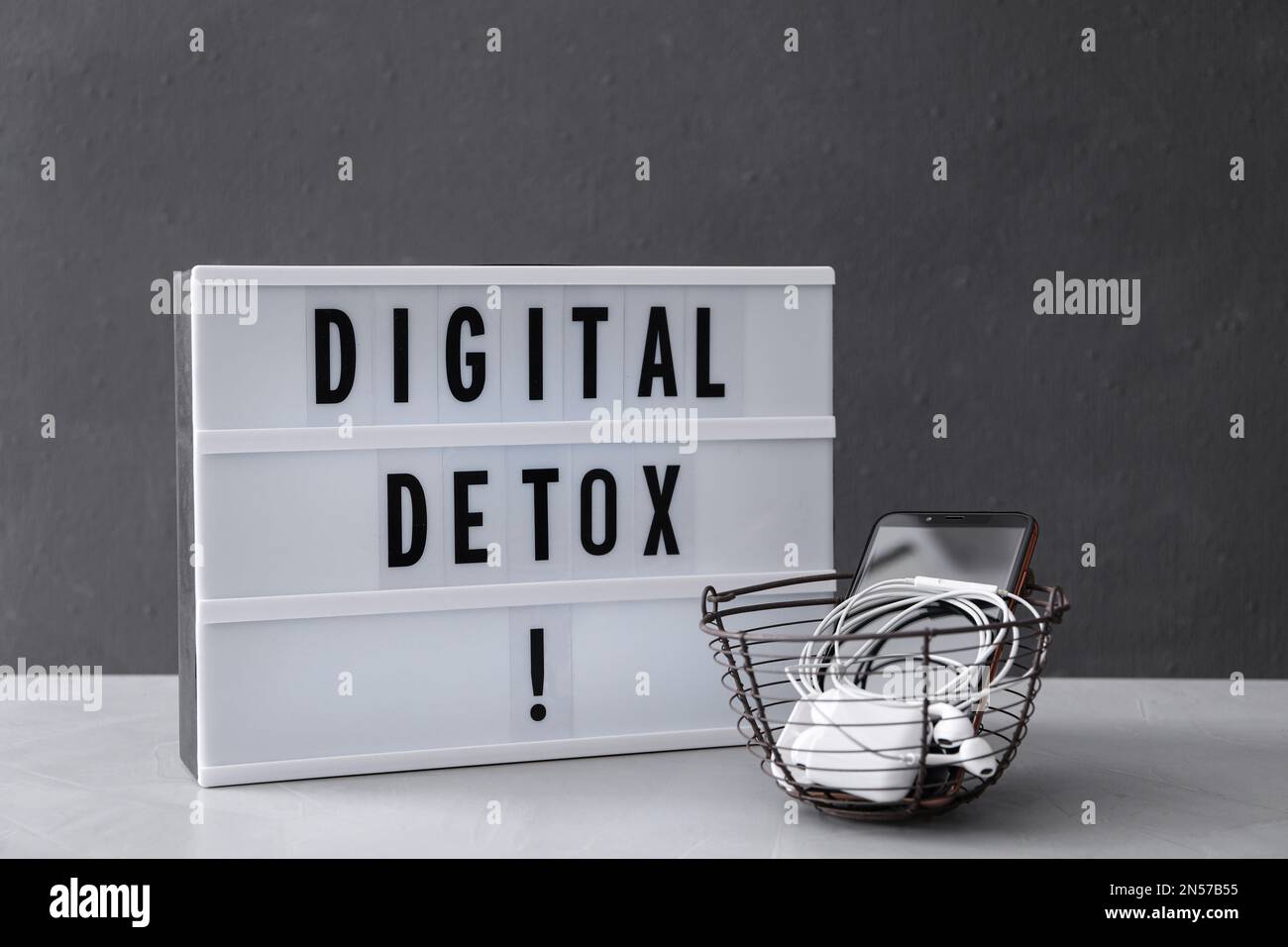 Trash bin of different gadgets and lightbox with words DIGITAL DETOX on ...