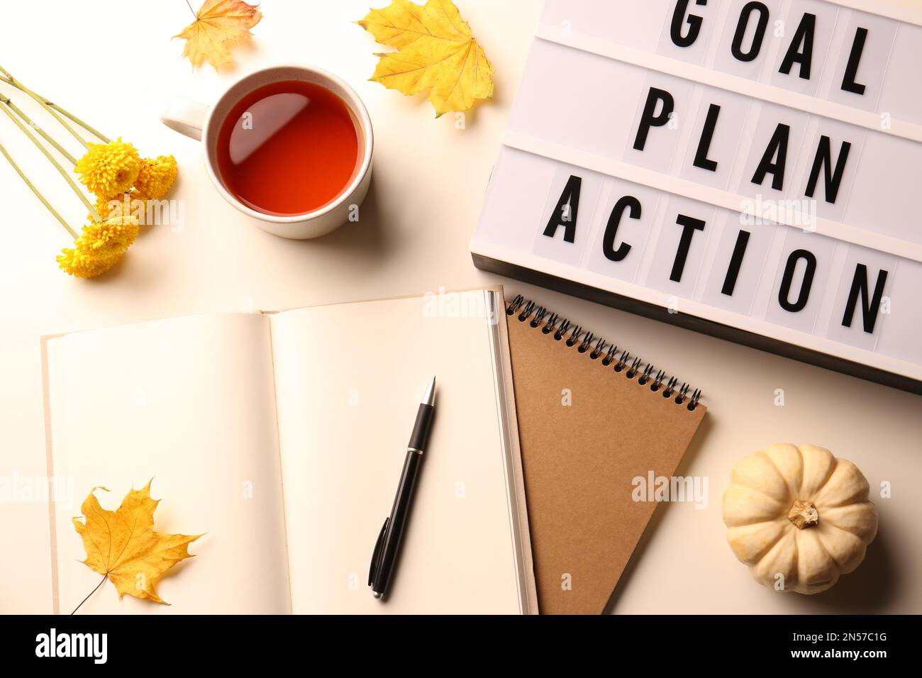 Light box with words Goal, Plan, Action, cup of tea, stationery and ...