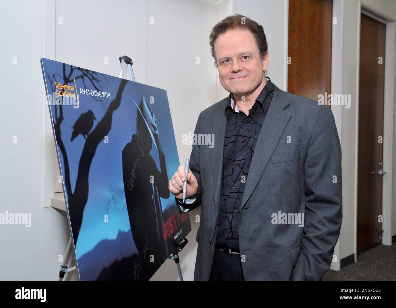 Tom O’Neil signs a poster at "An Evening with Justified," on Wednesday ...