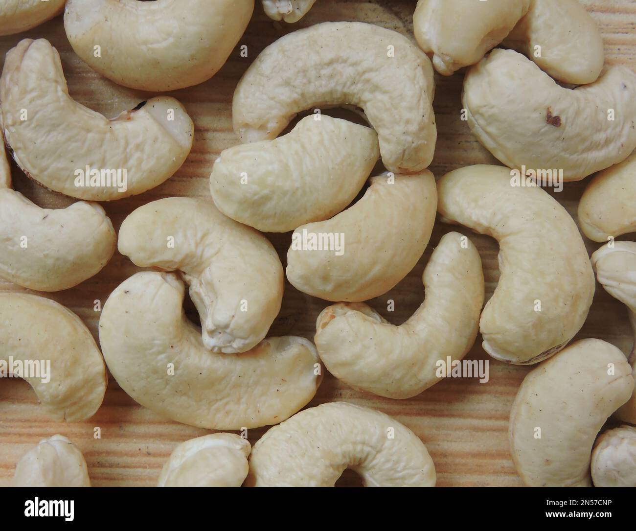 Cashew nuts are seeds produced from an evergreen tropical tree named ...