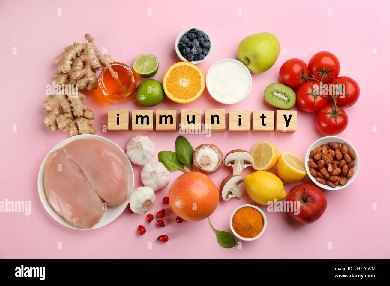 Set of natural products and cubes with word Immunity on pink background ...