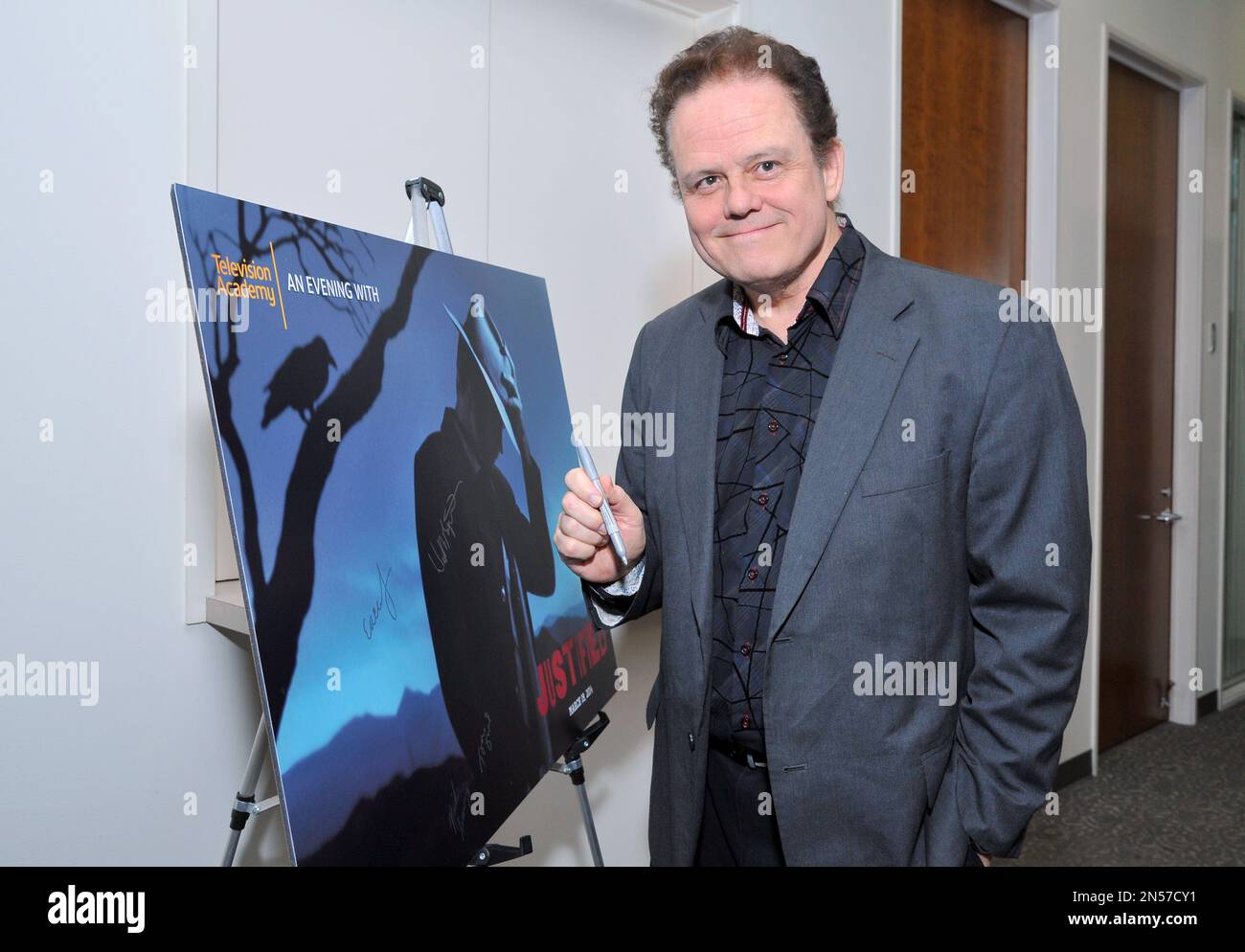 Tom O'Neil signs a poster at "An Evening with Justified," on Wednesday ...